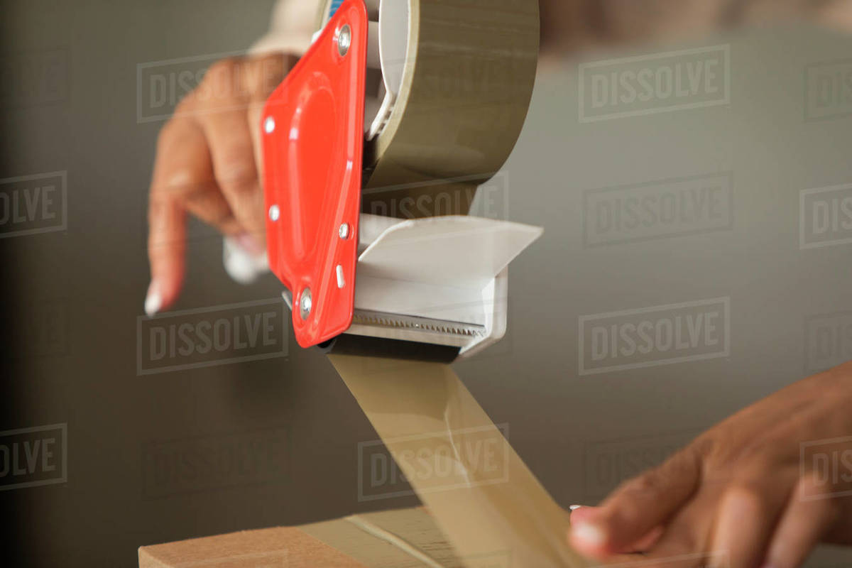 Close up female shop owner taping package for shipping - Stock Photo ...