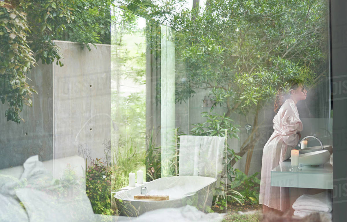 Woman in bathrobe in luxury modern bathroom - Stock Photo - Dissolve
