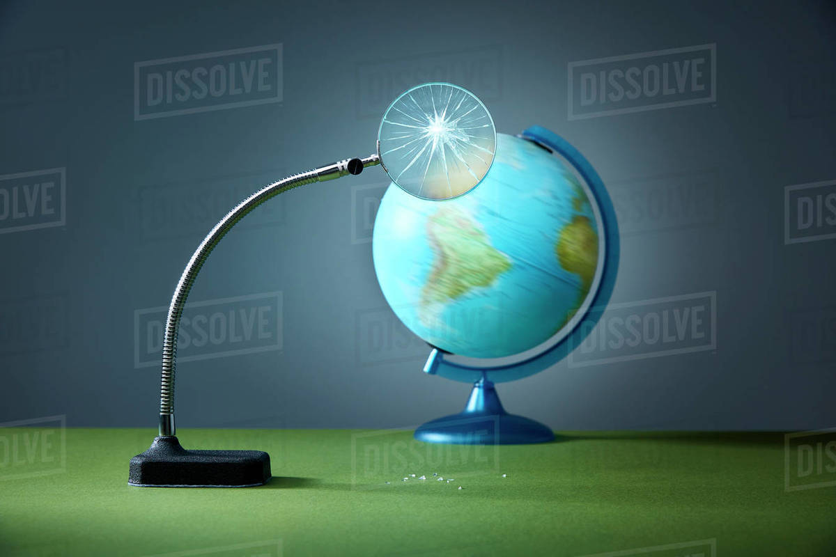 Broken magnifying glass over spinning globe - Royalty-free Stock Photo ...