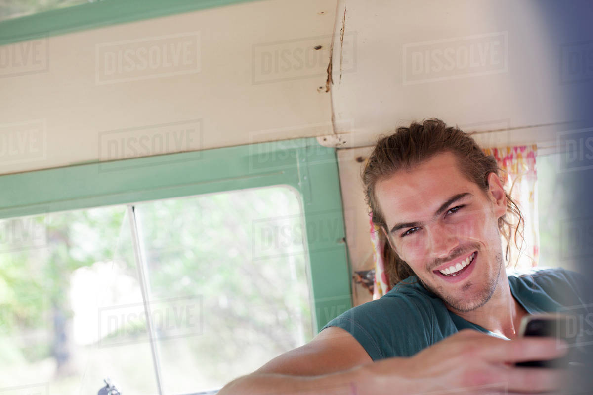 Man smiling in camper van - Royalty-free Stock Photo | Dissolve