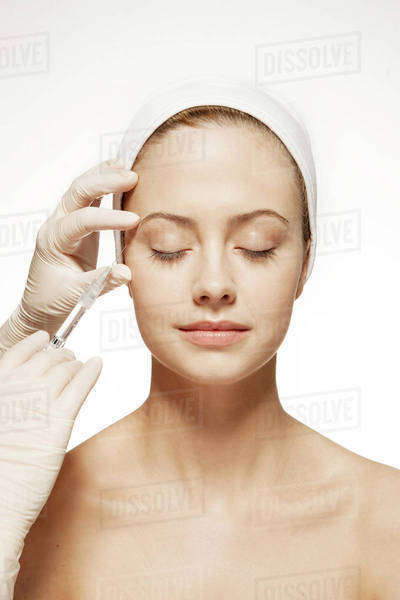 Doctor injecting botox into woman's face - Royalty-free Stock Photo ...