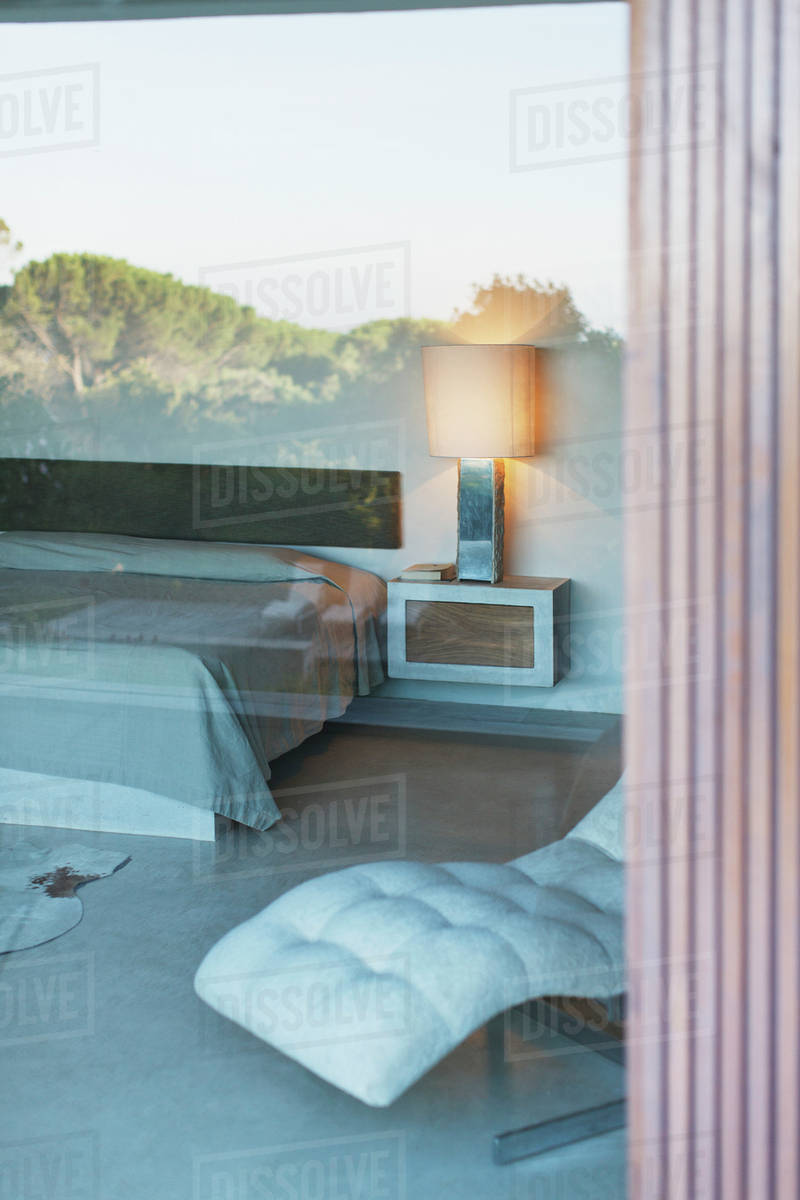 View of modern bedroom through window - Stock Photo - Dissolve
