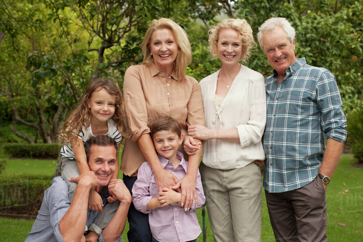 Portrait of multi-generation family smiling outdoors - Royalty-free ...