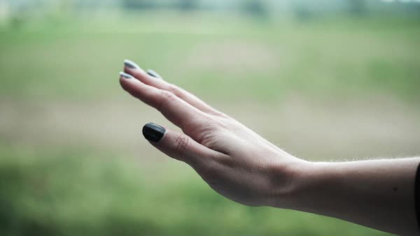 Slow motion medium shot of a hand playing with airflow - HD Royalty ...