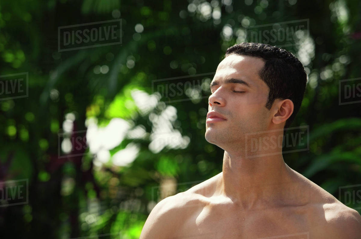 Man with face in sun, eyes closed - Stock Photo - Dissolve