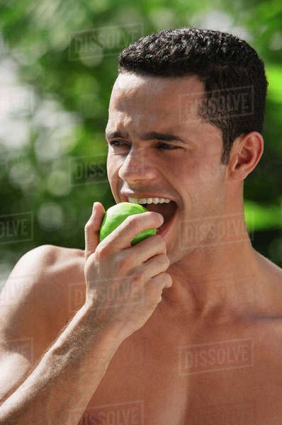 Man biting into apple - Stock Photo - Dissolve