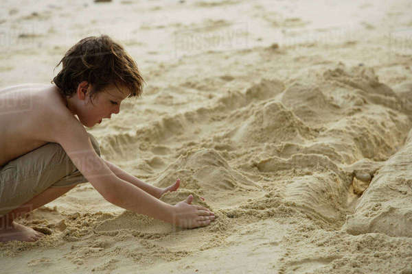Boy playing in sand - Royalty-free Stock Photo | Dissolve