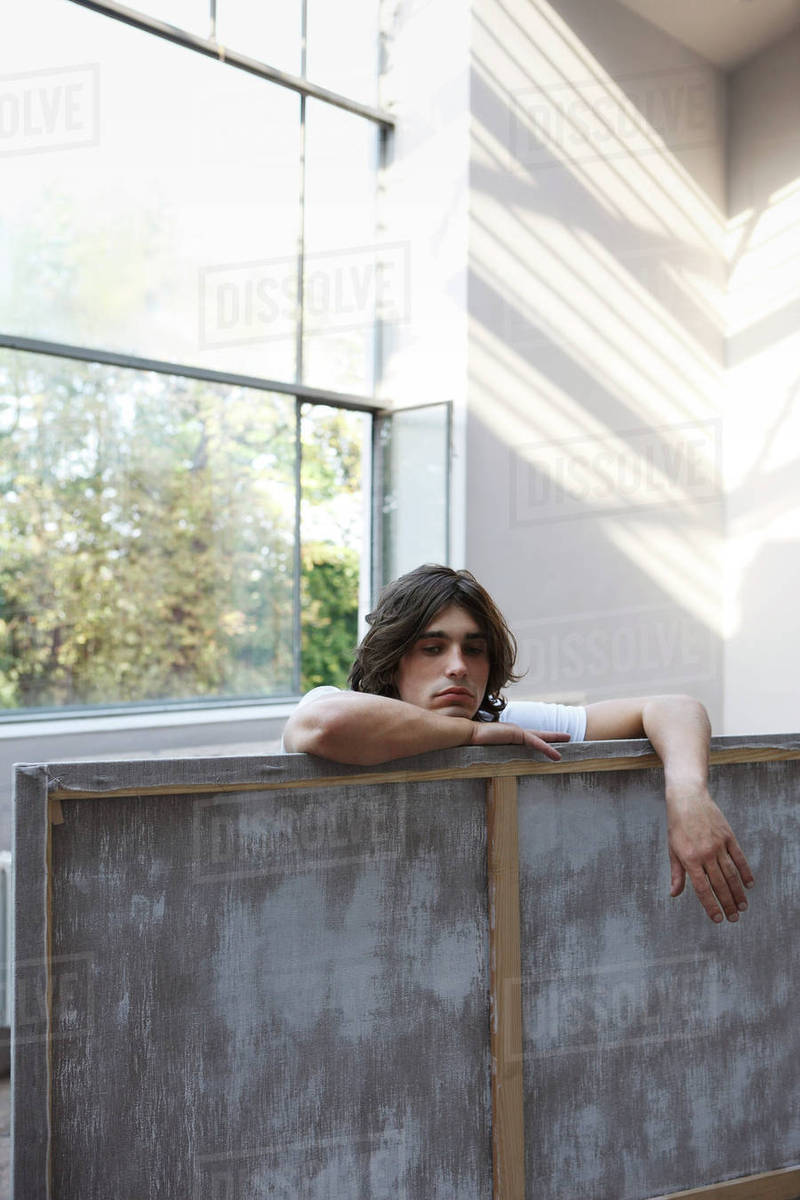 Artist leaning on canvas - Royalty-free Stock Photo | Dissolve