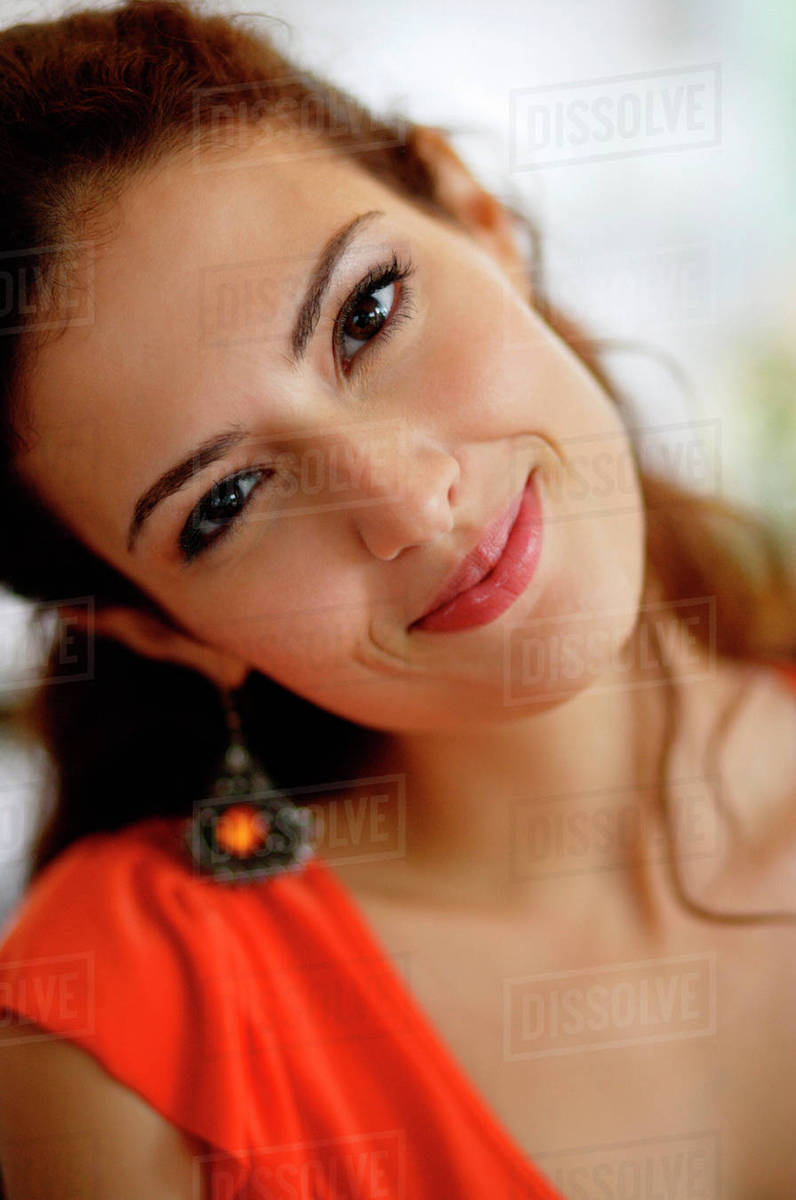 Woman looking at camera, smiling - Stock Photo - Dissolve