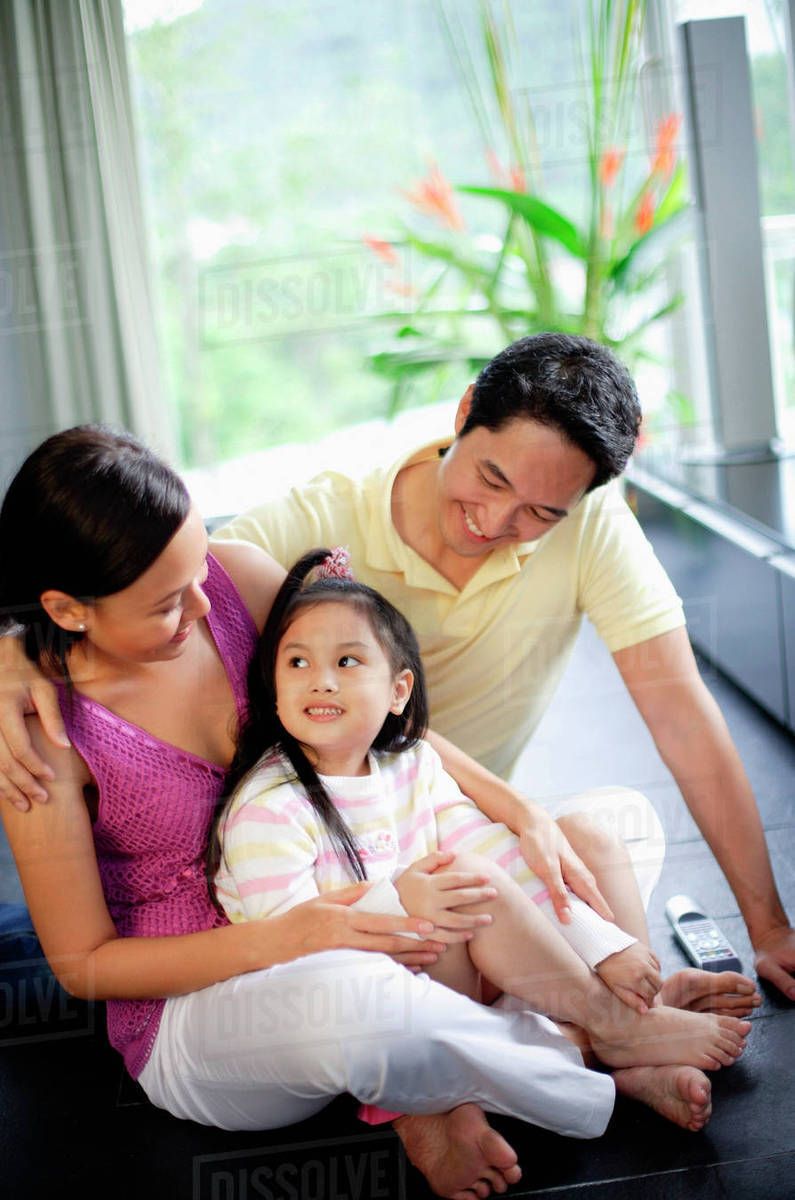 Family of three, portrait - Royalty-free Stock Photo | Dissolve