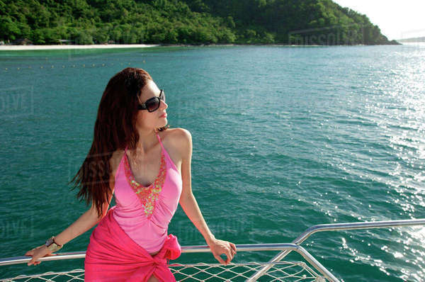 Woman on boat, leaning on railing, looking away - Royalty-free Stock ...