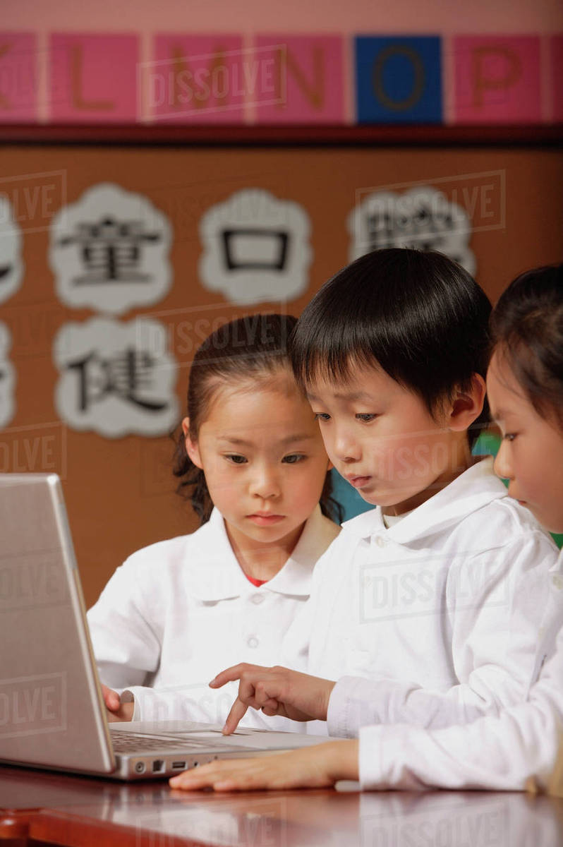 Young students using laptop in class, schoolboy typing on keypad ...