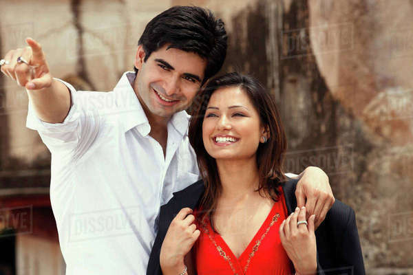 Man pointing out something to woman - Royalty-free Stock Photo | Dissolve