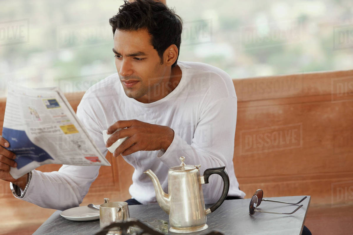 Man reading newspaper - Royalty-free Stock Photo | Dissolve
