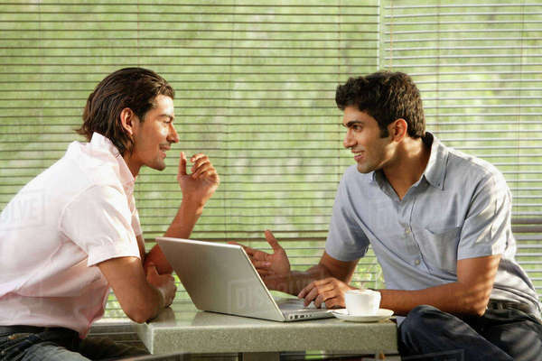 Two men at laptop in cafe - Royalty-free Stock Photo | Dissolve