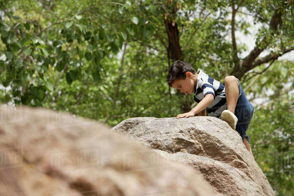 Boy climbing on rocks - Royalty-free Stock Photo | Dissolve