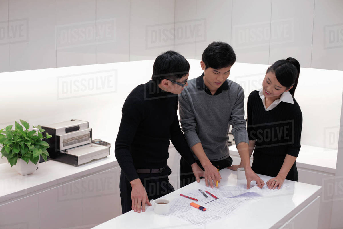 Three people working together in modern office - Stock Photo - Dissolve
