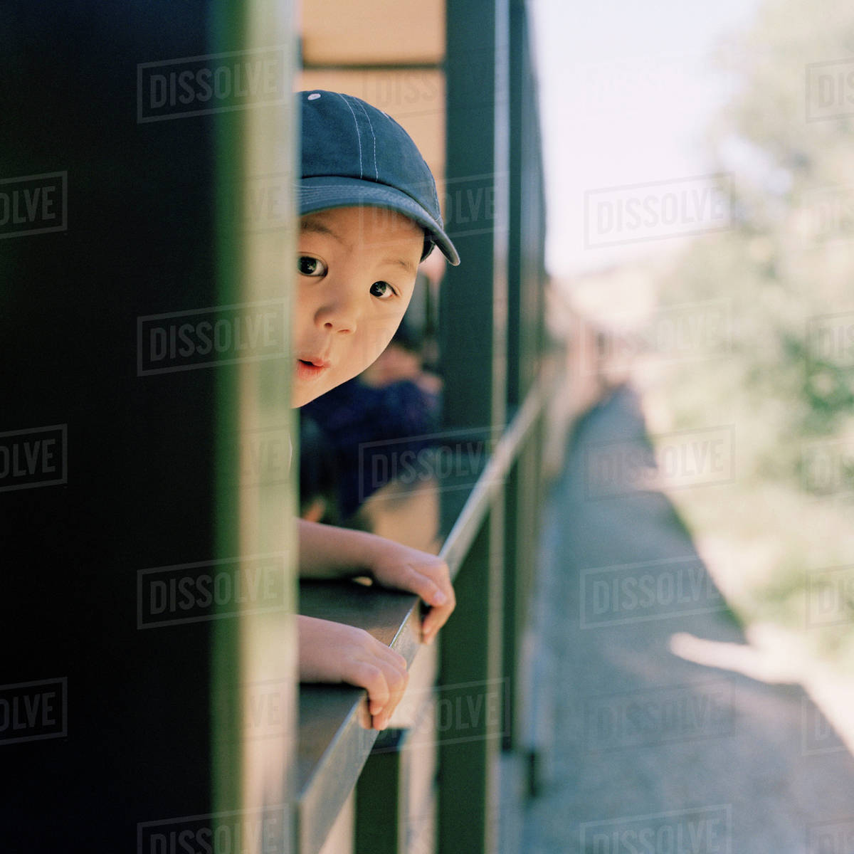 An excited boy leaning out of a train window - Stock Photo - Dissolve