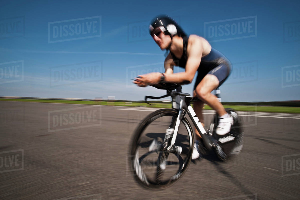 A cyclist on a racing bicycle, side view - Stock Photo - Dissolve