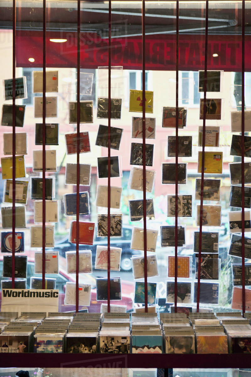 A window display of hanging compact discs in a record shop - Royalty ...