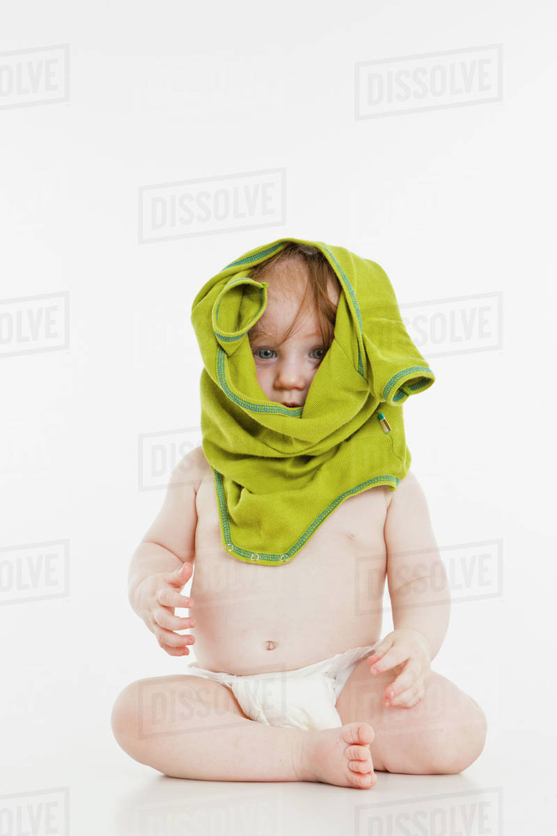 A baby girl with clothing on her head - Royalty-free Stock Photo | Dissolve