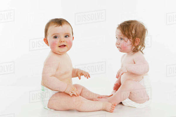 Two babies sitting together - Royalty-free Stock Photo | Dissolve