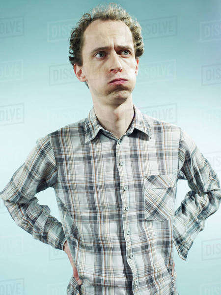 A man with puffed cheeks looking away with uncertainty - Royalty-free ...