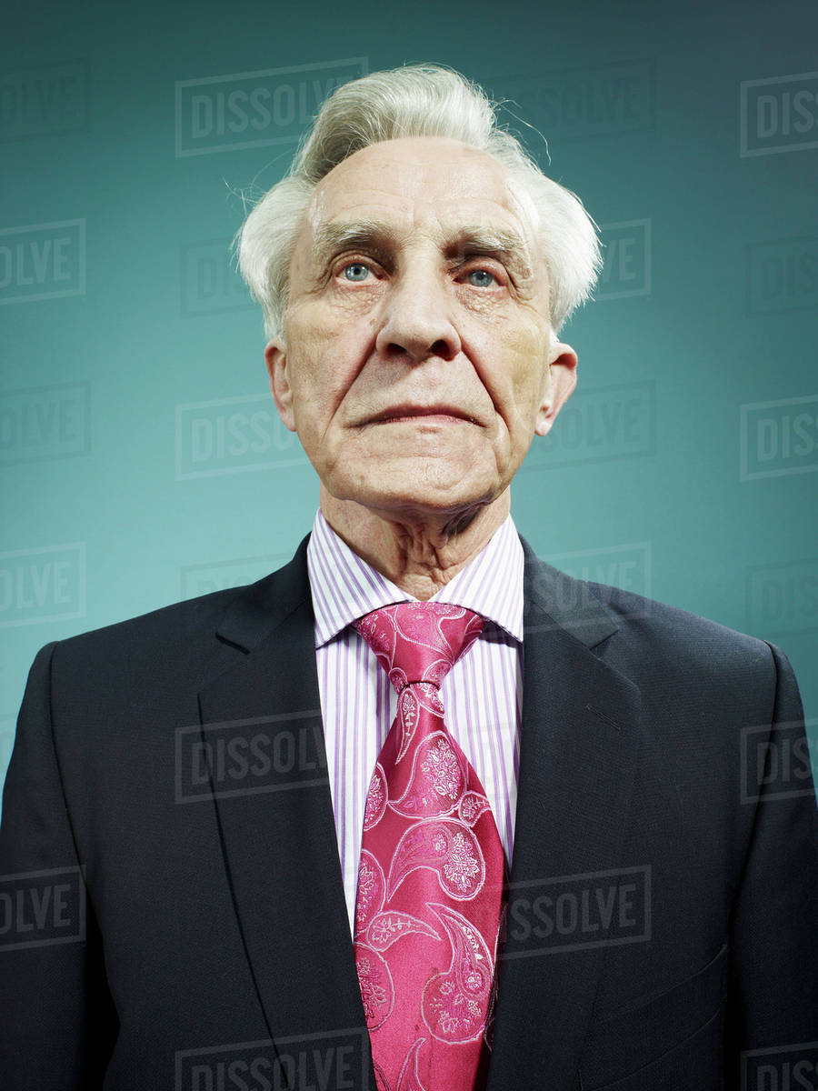 An elegant senior man wearing a suit and bright pink tie - Stock Photo ...