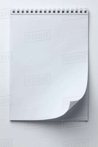 A blank sketch pad with curled up page corner - Stock Photo - Dissolve