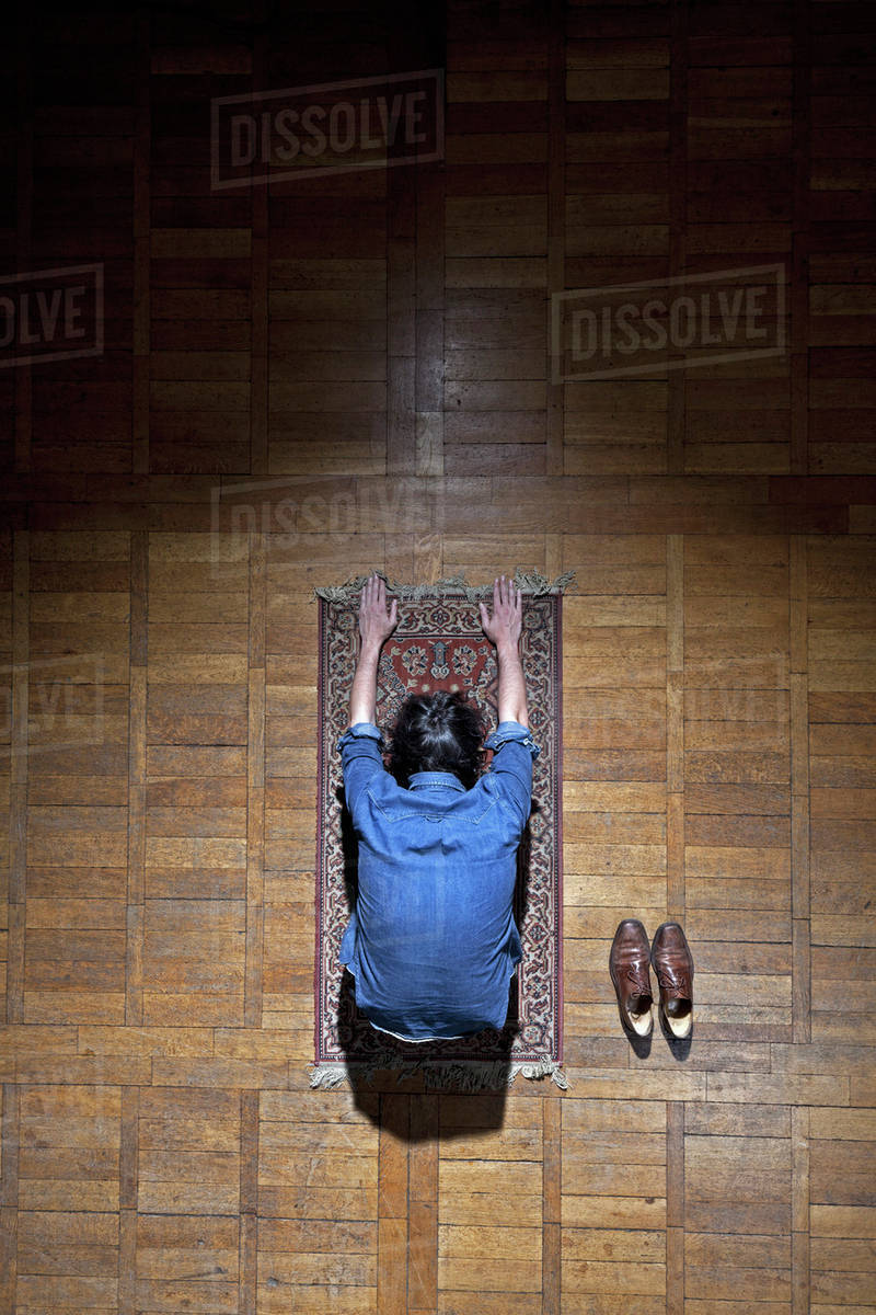 A man praying on a mat - Royalty-free Stock Photo | Dissolve