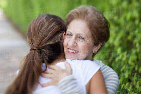 A senior woman hugging a young woman - Royalty-free Stock Photo | Dissolve