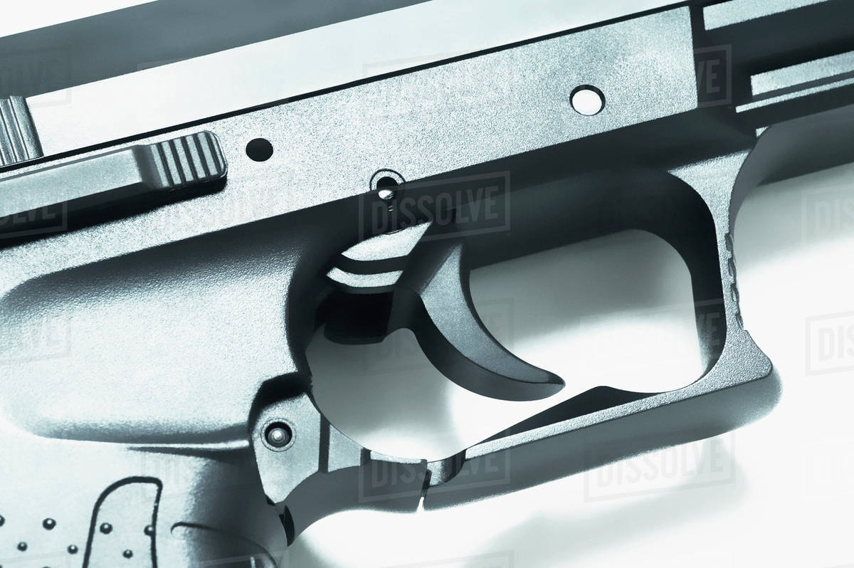 Close-up of the trigger on a handgun - Stock Photo - Dissolve