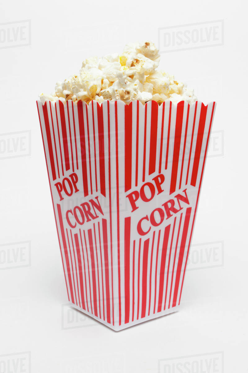Studio shot of a red striped carton of popcorn with Popcorn printed on ...