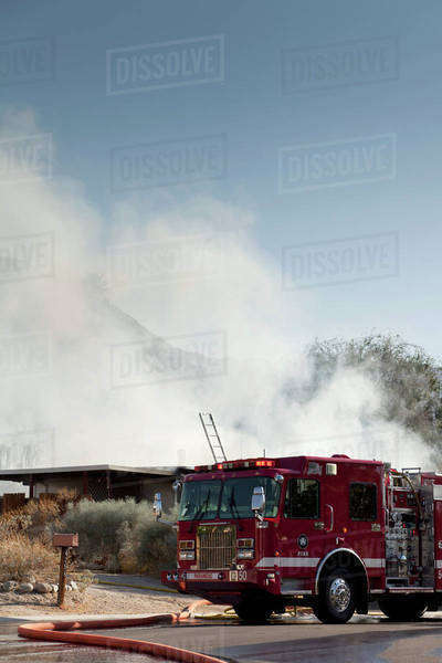 A fire truck next to a burning house in a suburb - Royalty-free Stock ...