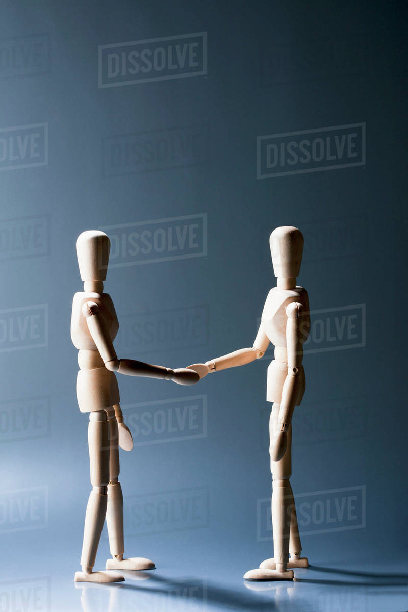 Two artist's figures shaking hands - Royalty-free Stock Photo | Dissolve