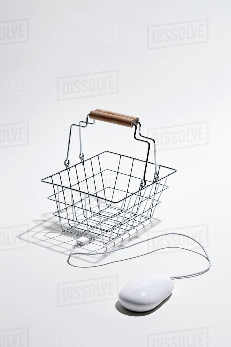 Computer mouse connected to shopping basket for online shopping ...
