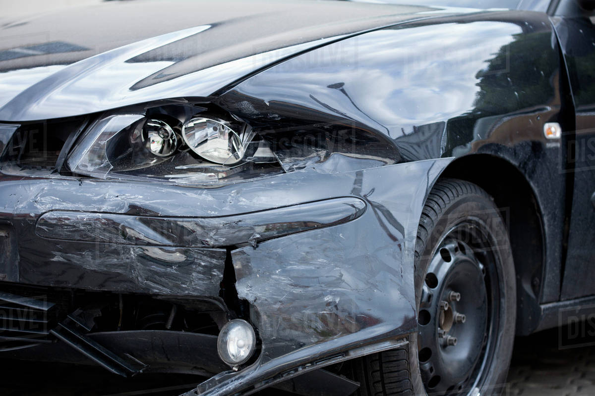 Damaged car with distorted reflection of town - Stock Photo - Dissolve