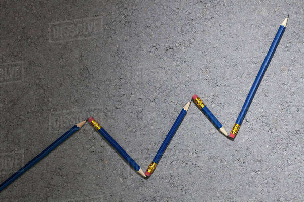 Pencils arranged to depict an ascending line graph - Stock Photo - Dissolve