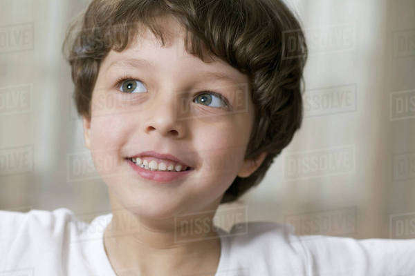 A cute, smiling young boy looking up and to the side - Royalty-free ...