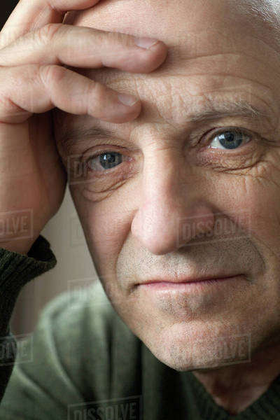 A senior man with his hand on his forehead, close-up - Royalty-free ...