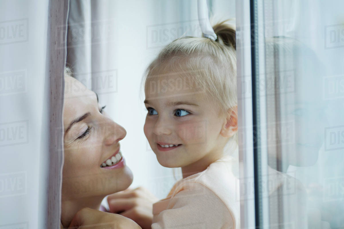 A cheerful mother and her young daughter, face to face - Stock Photo ...