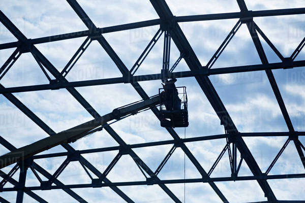 Welder on crane welding roof beam - Royalty-free Stock Photo | Dissolve