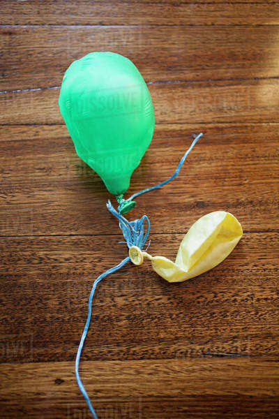 Two deflated balloons on a wooden table - Royalty-free Stock Photo ...