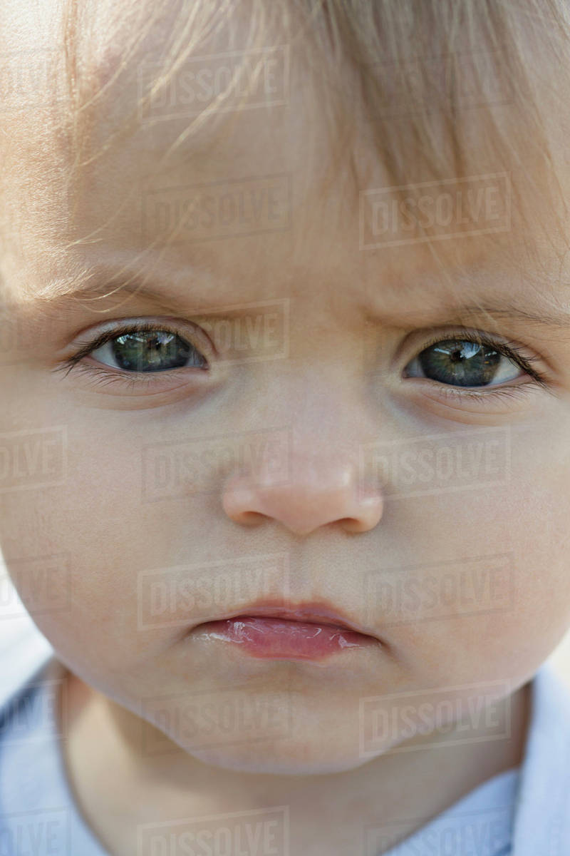 A young girl frowning in concentration, close-up of face - Stock Photo ...