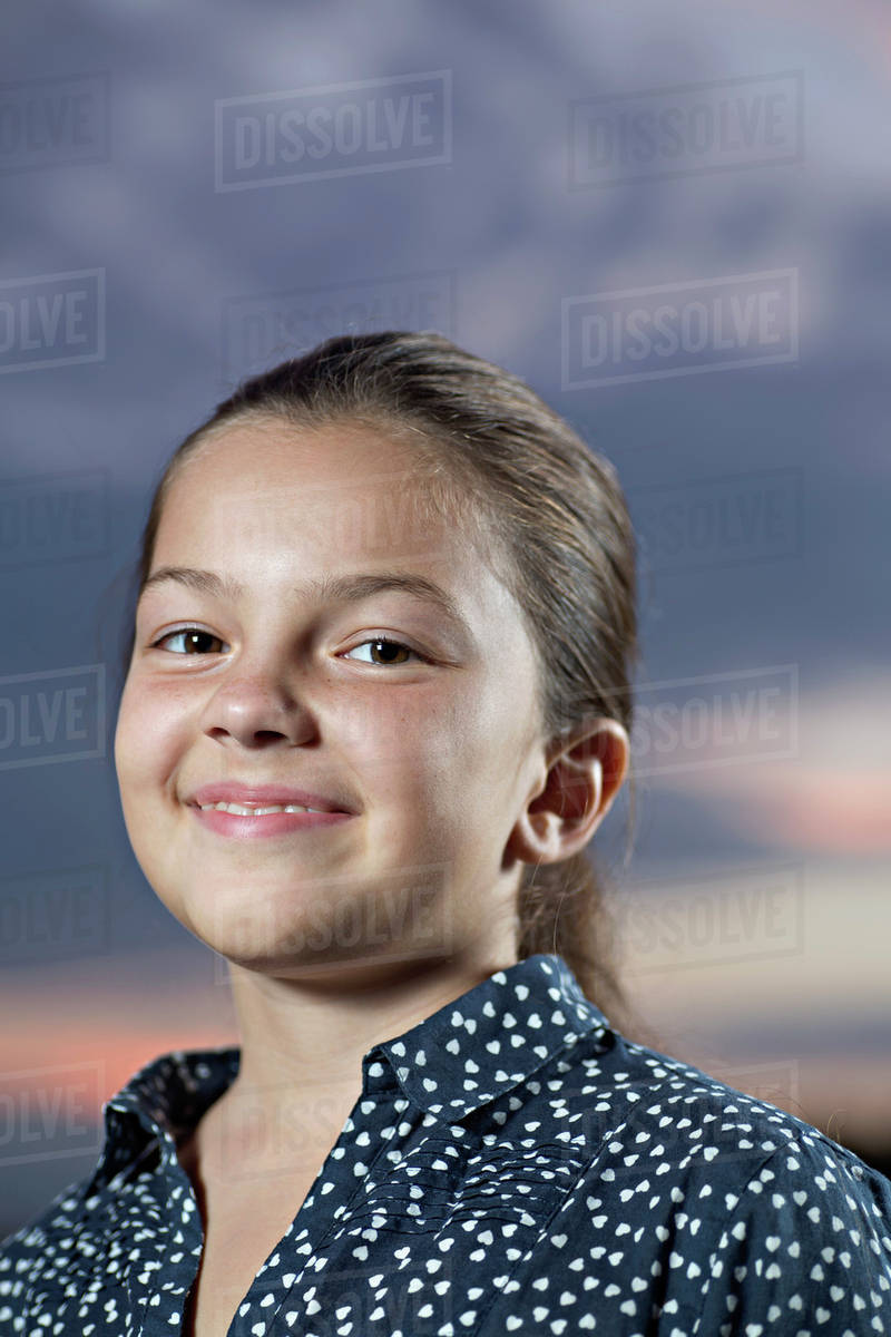 A happy girl smiling into the camera - Royalty-free Stock Photo | Dissolve