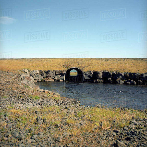 A culvert pipe carrying water for a stream under a field - Royalty-free ...