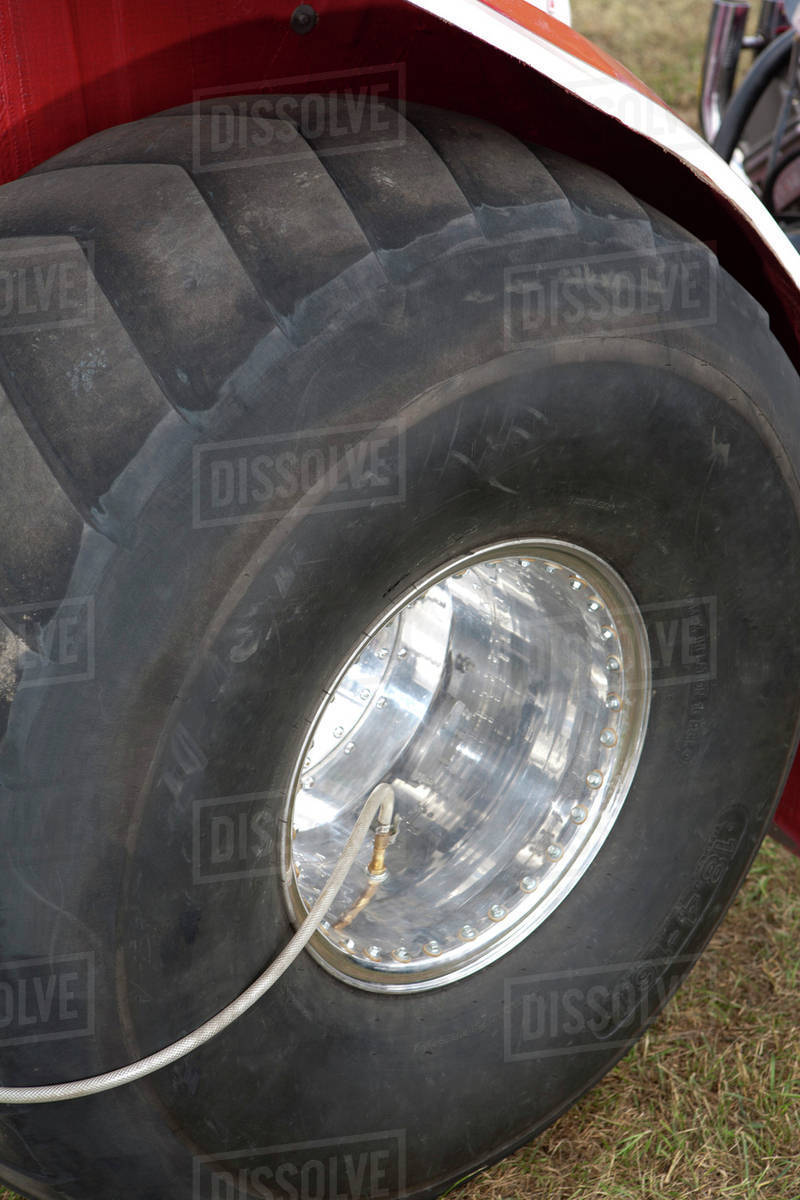 Close-up, tractor tire being inflated by air pump - Stock Photo - Dissolve