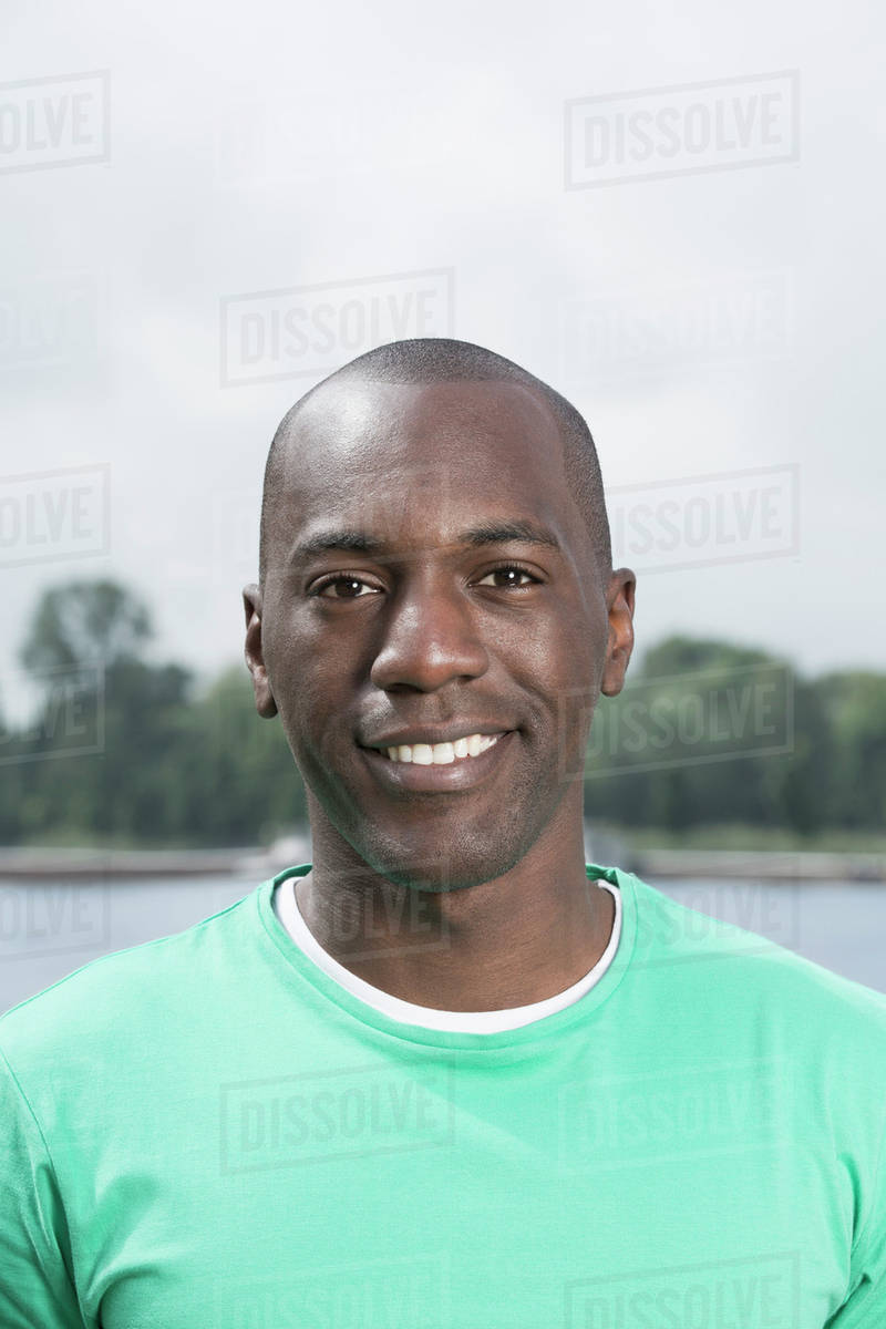 Portrait of smiling man in green t-shirt - Royalty-free Stock Photo ...