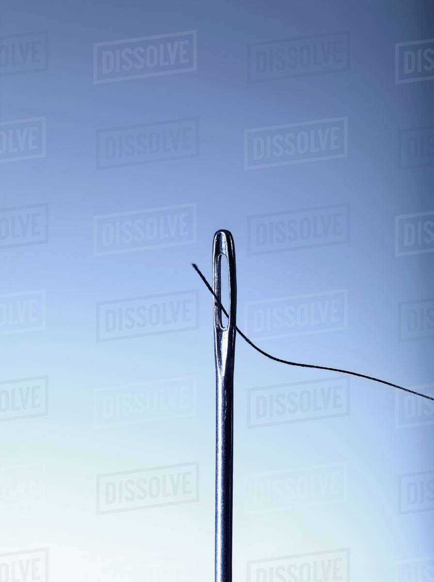 A needle being threaded, close-up - Royalty-free Stock Photo | Dissolve