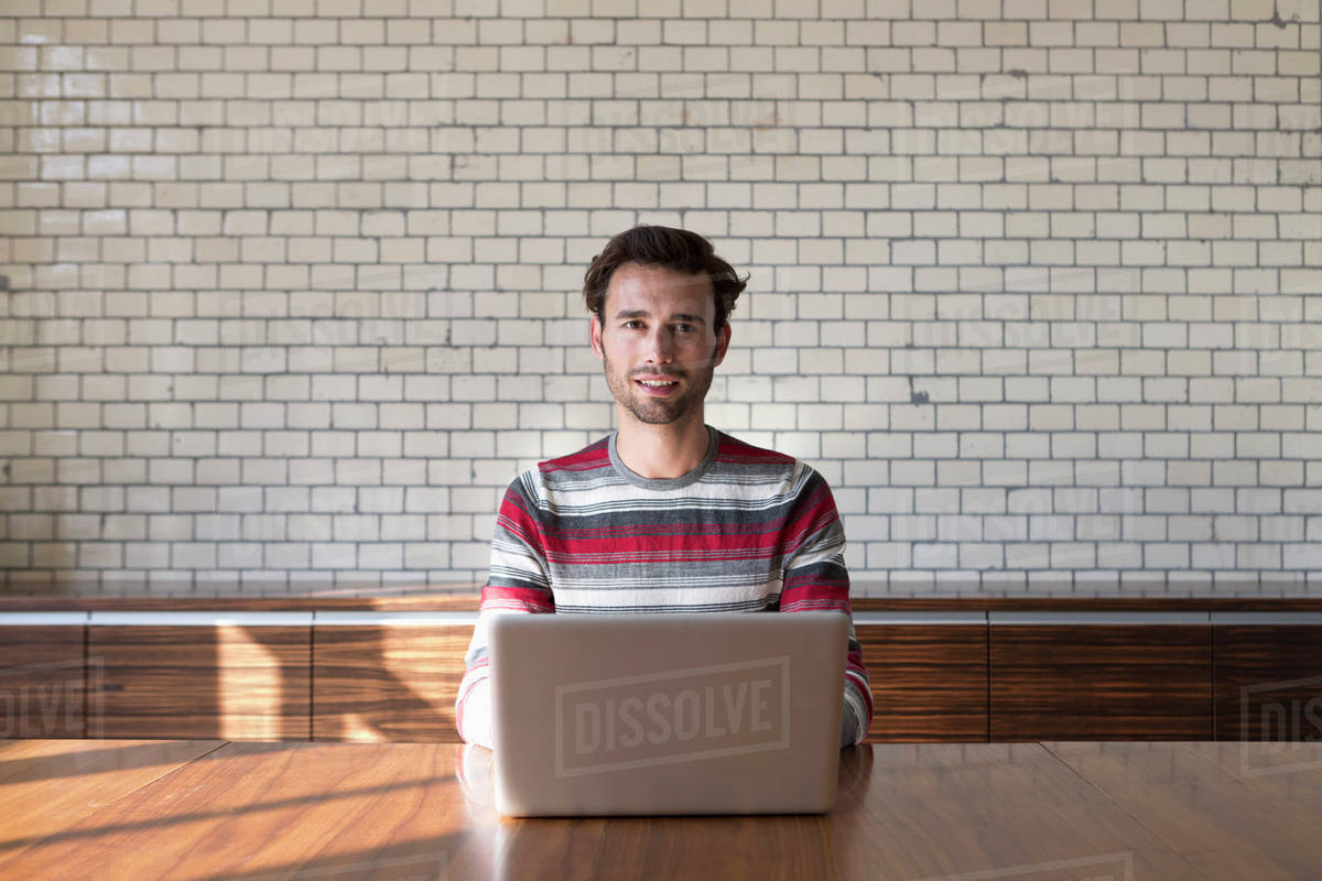 Man using laptop, portrait - Royalty-free Stock Photo | Dissolve